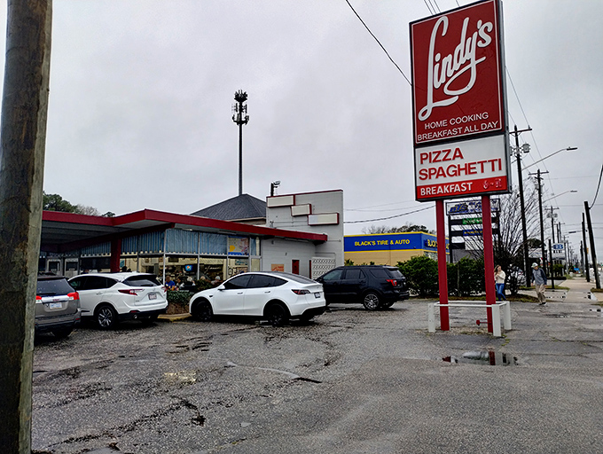 That classic red sign beckons hungry travelers like a lighthouse for breakfast-all-day enthusiasts.