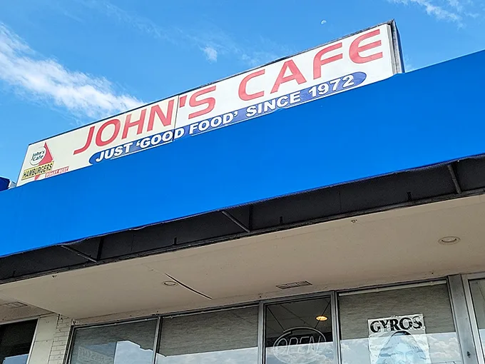 That blue awning is like a breakfast beacon, guiding hungry souls to John's Cafe's legendary hash browns and omelets.