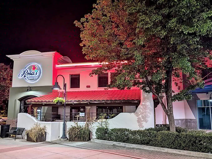Illuminated against the twilight sky, Rosa's becomes a beacon for night owls craving that perfect cheese pull.