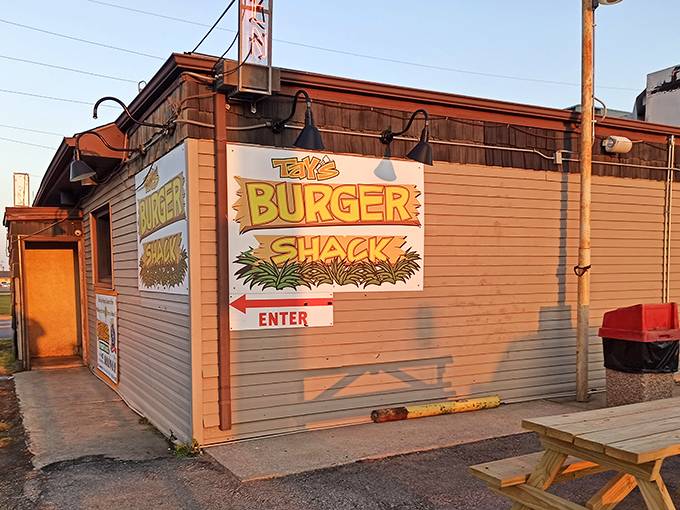 Sunlight casts a golden glow on Tay's – a modest burger temple where simplicity and flavor create a religious experience.