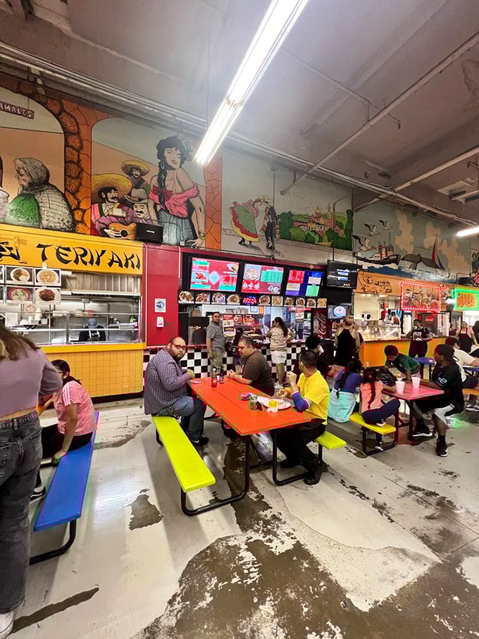 The food court: where vibrant murals watch over colorful picnic tables as families gather for authentic meals that transport you across borders without a passport.