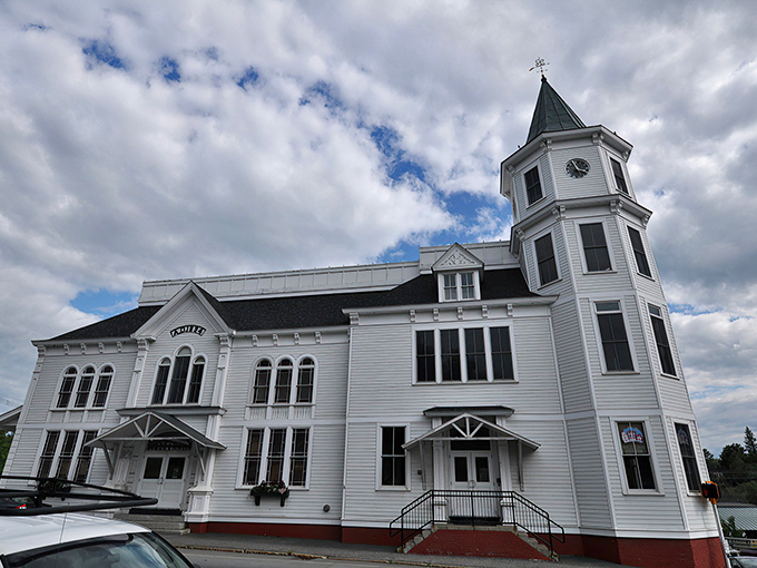 This pristine white town building with its elegant clock tower isn't just pretty—it's where the business of small-town democracy unfolds with New England efficiency.