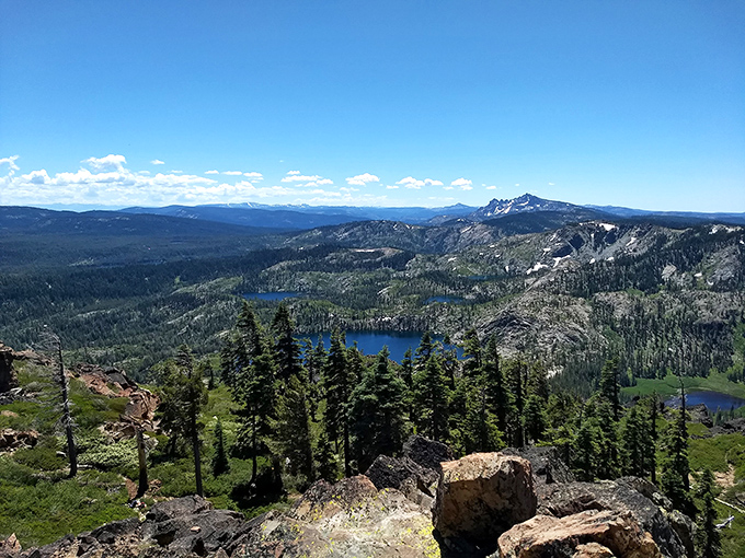 The view that makes every uphill step worthwhile. From Mount Elwell's summit, the Lakes Basin area unfolds like nature's own IMAX experience.