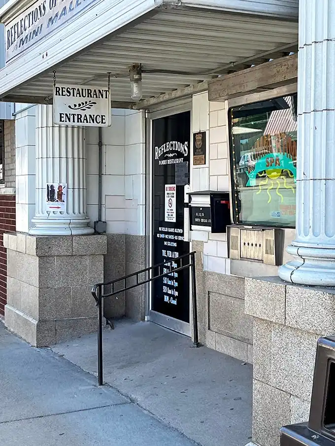 The historic Reflections Family Restaurant entrance promises hearty meals with a side of nostalgia. No molecular gastronomy here, just honest cooking worth the trip.