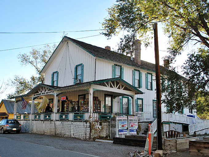 The Old Boarding House Mercantile stands as a time capsule with its vintage white clapboard and welcoming porch—small-town America preserved.