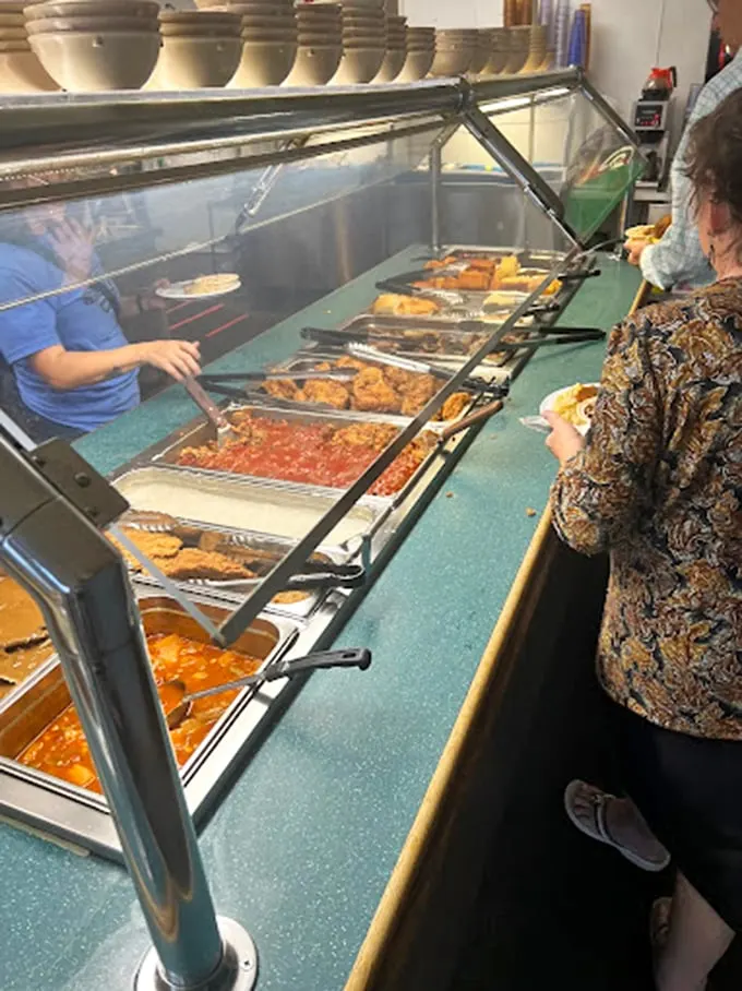 The buffet line – where dreams are made and diets go to die. Each steaming tray promises a different journey into Southern comfort.