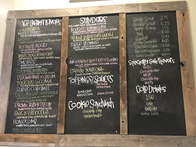 The chalkboard menu reads like poetry for your taste buds—each flavor a promise of happiness written in whimsical lettering.