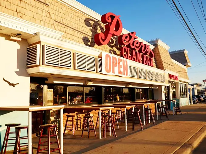 Johnny's blue-and-white facade gleams under perfect skies – the kind of place where calories don't count and seafood dreams come true.