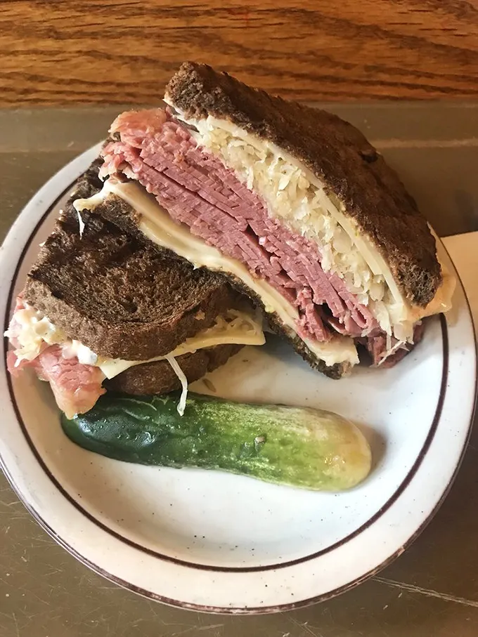 This isn't just a sandwich; it's a masterpiece of meat architecture that makes you question every other Reuben you've ever loved.