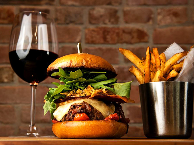 This isn't just a burger—it's an architectural marvel of beef and cheese that requires both hands and zero shame.