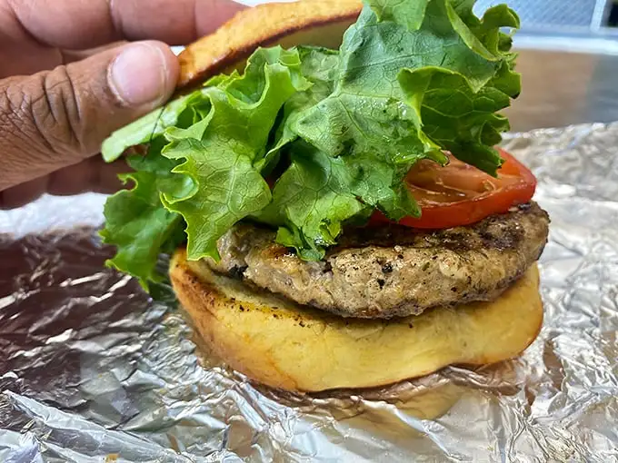 This isn't just a veggie burger—it's proof that plant-based doesn't mean pleasure-free. Fresh lettuce and tomato add crunch to a patty that could convert even dedicated carnivores.