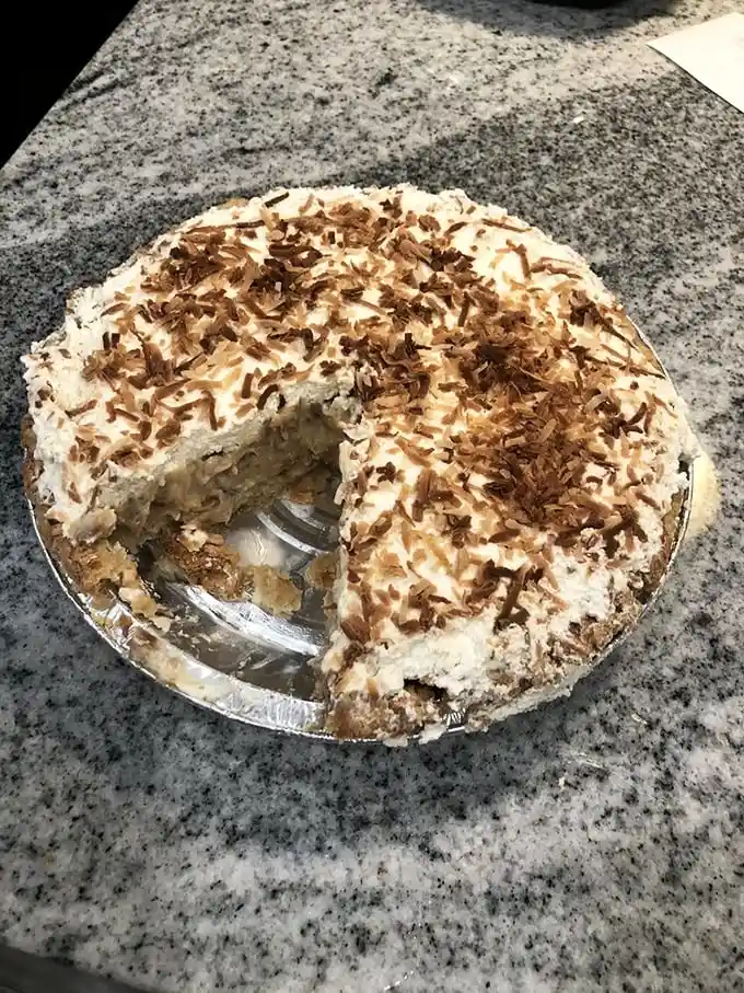 This coconut cream pie doesn't just flirt with perfection—it's in a committed relationship. Toasted coconut flakes are the jewelry on this masterpiece.