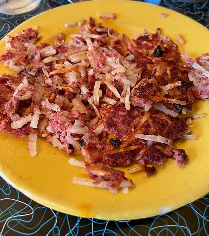 The star of the show in all its glory – corned beef hash with crispy edges and tender centers. Not a sad can-opener situation in sight!
