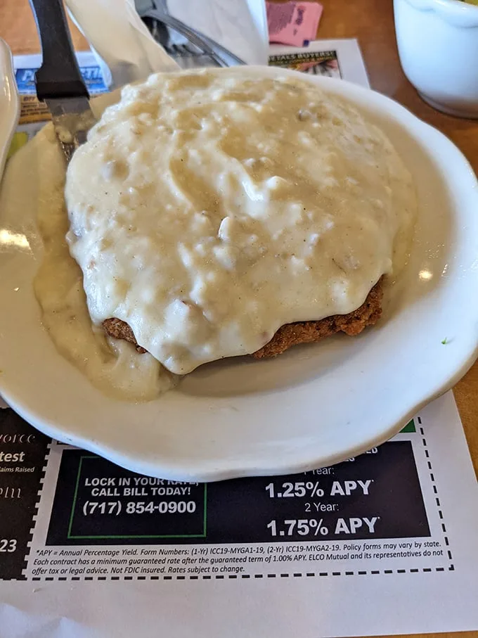 Country fried steak smothered in creamy gravy – a dish so good it might make you forget your table manners.