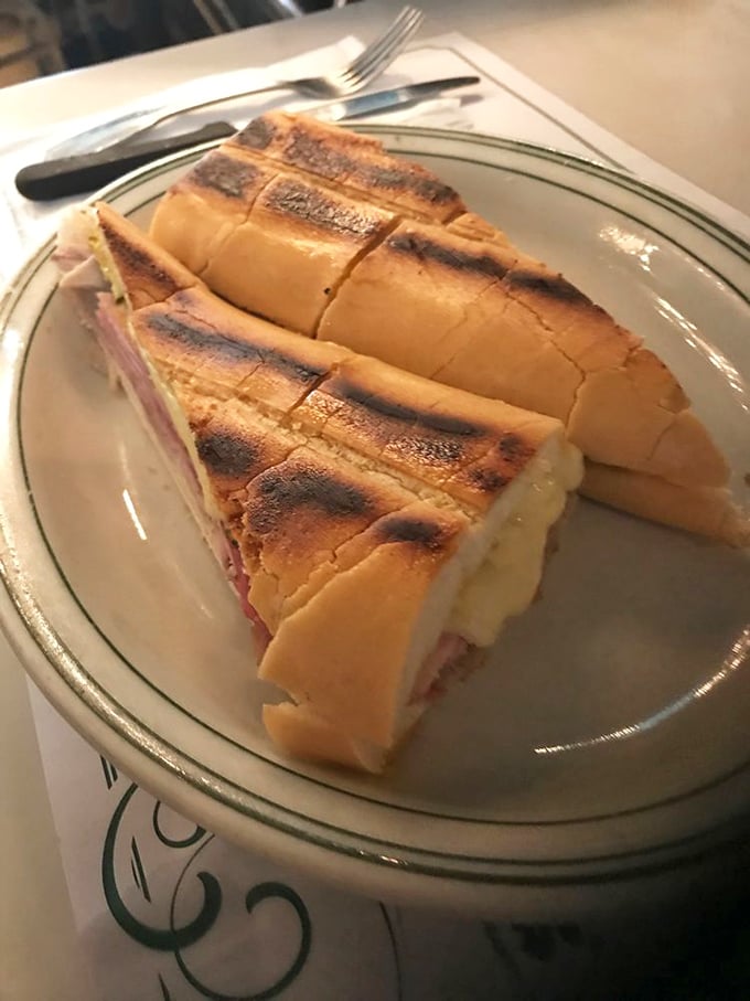 The Cuban sandwich at Versailles isn't just pressed—it's transformed into a crispy, melty masterpiece that makes other sandwiches question their life choices.