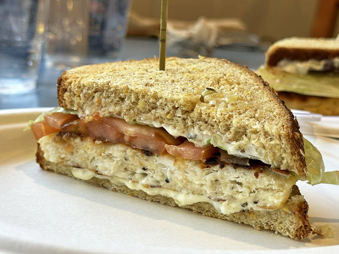 This halibut sandwich isn't just lunch—it's a religious experience between two slices of bread. The tomato adds color, but the fish is the undisputed star.