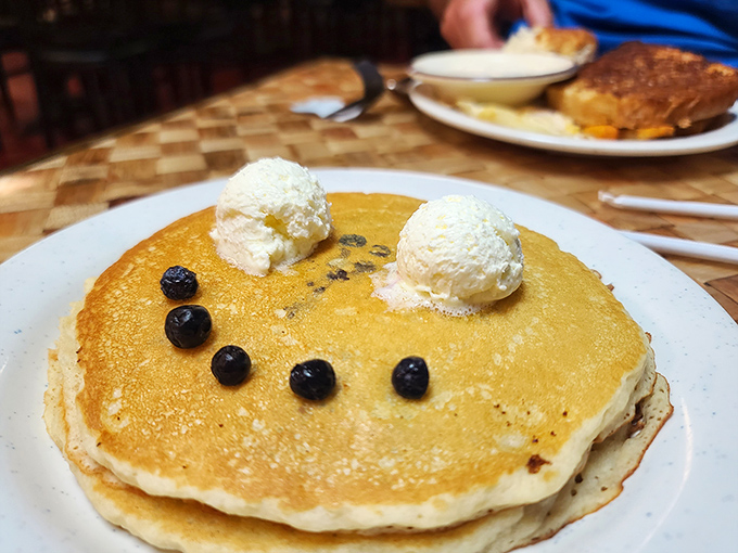 Golden pancakes with a perfect smiley face of blueberries and dollops of butter – breakfast doesn't get more cheerful than this edible emoji.