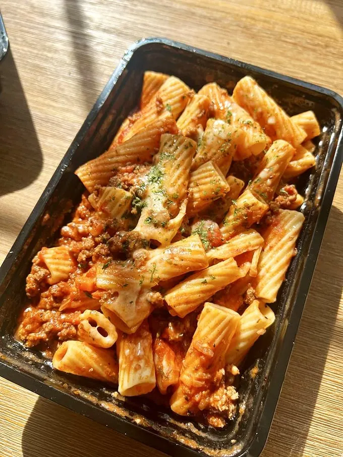 Rigatoni that's dressed for success. The meat sauce clings to each pasta tube like it was designed specifically for this moment.