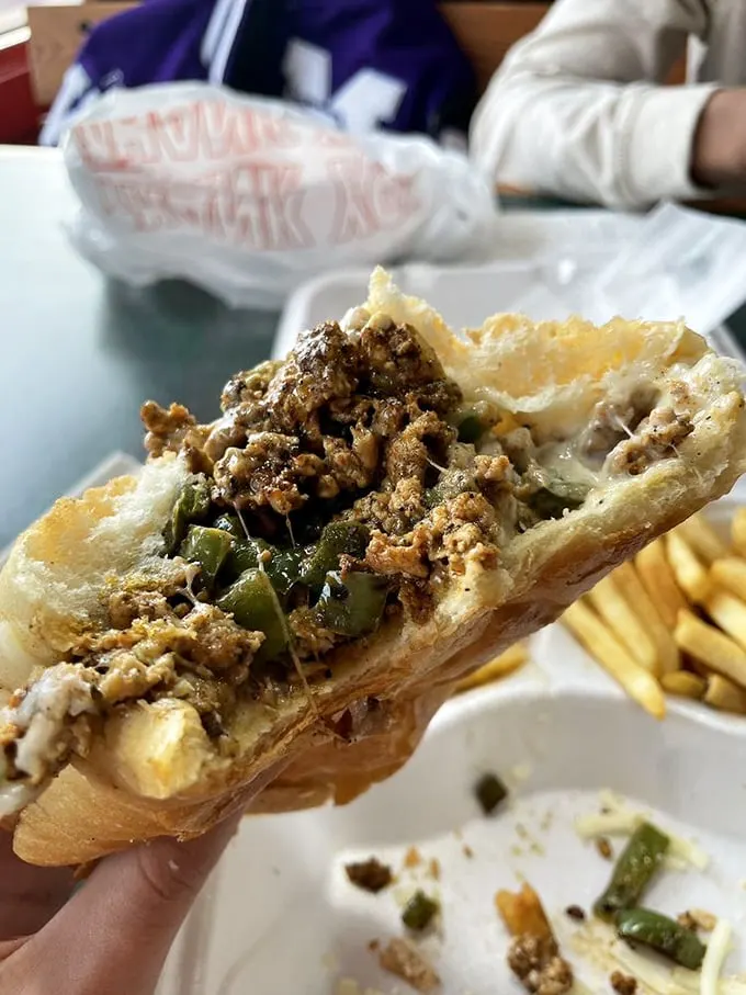Cross-sectional evidence of sandwich perfection. The strategic layering of meat, peppers, and melted cheese creates what scientists call "delicious architecture."