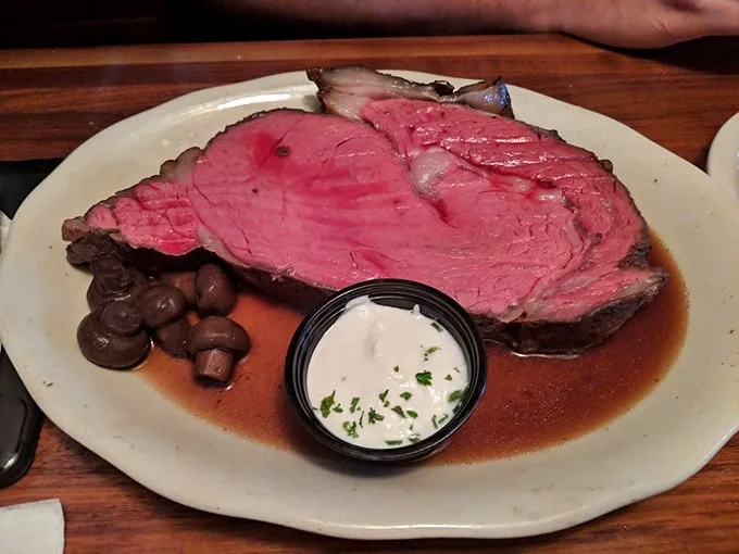 This isn't just prime rib; it's a masterpiece of meat – perfectly pink, surrounded by savory jus, with mushrooms and horseradish cream standing by for backup.