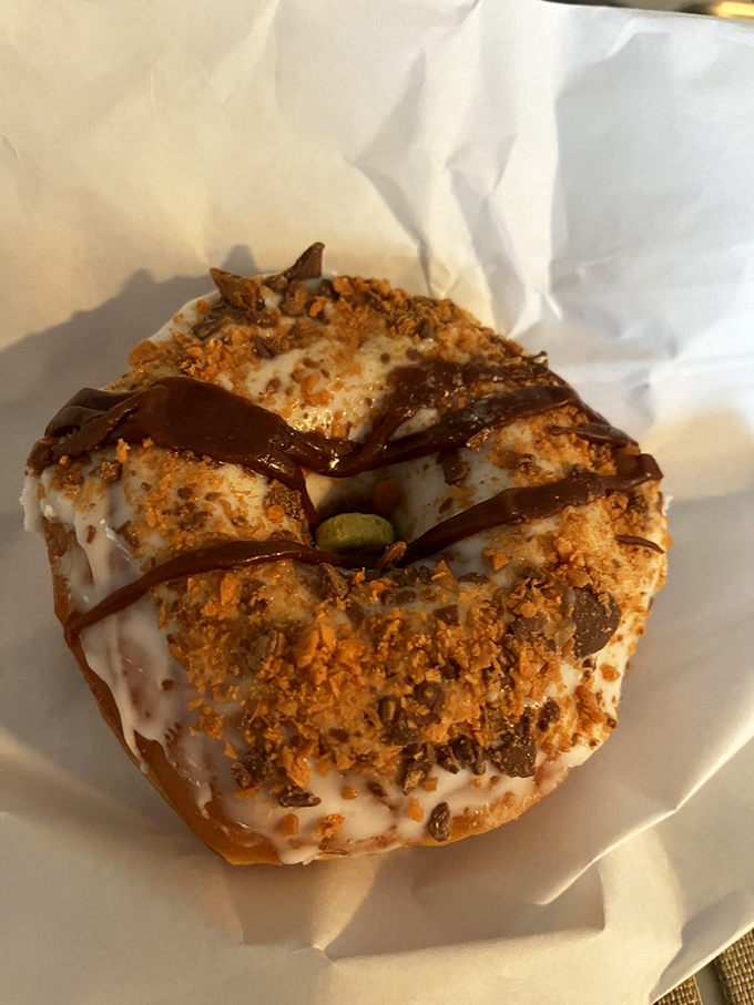 This isn't just a donut—it's a work of confectionery engineering where peanut butter meets chocolate in a relationship more perfect than any Hollywood romance.