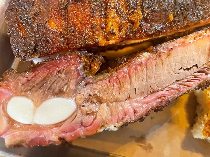 Behold the perfect smoke ring – that pink halo of flavor that separates barbecue artists from pretenders. These ribs have earned their bark.