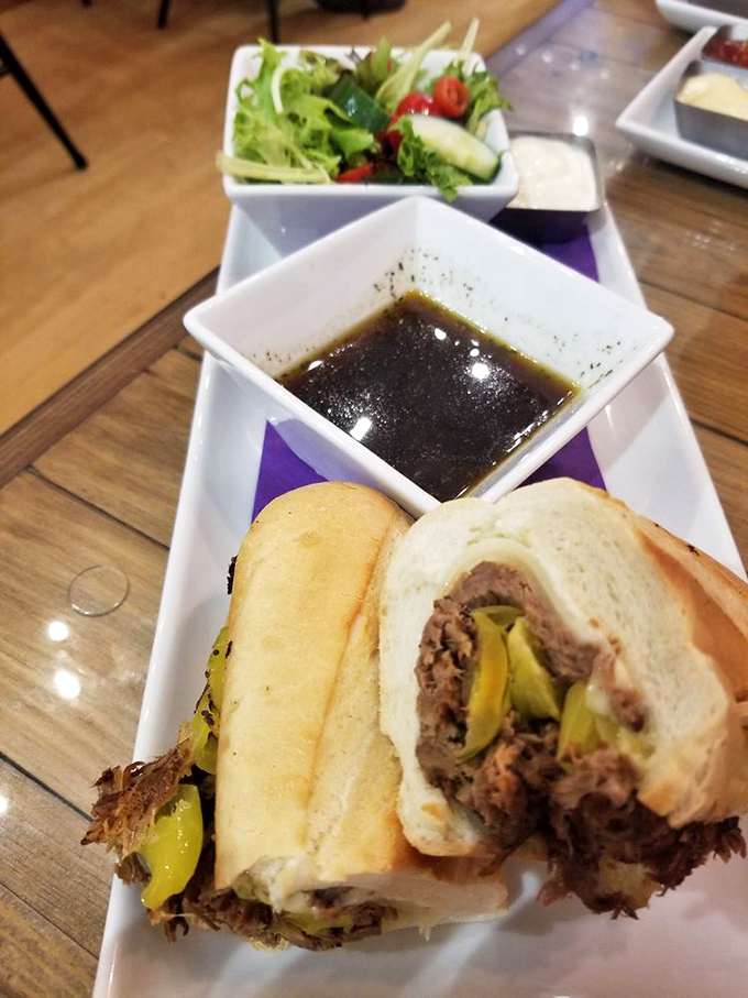 The French dip reimagined: tender roast beef, tangy peppers, and that au jus—oh, that au jus!—deep enough to baptize your taste buds.