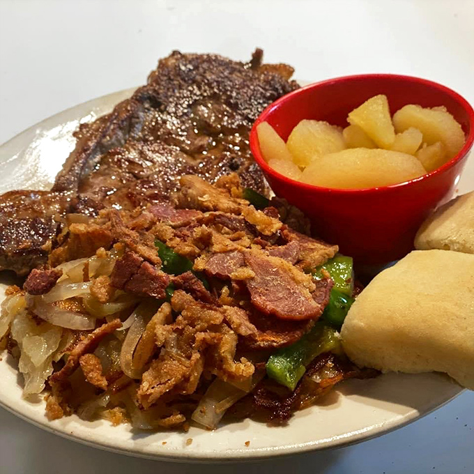 Steak with a side of sautéed onions and bacon bits—proof that sometimes the best accessories aren't worn, they're eaten.
