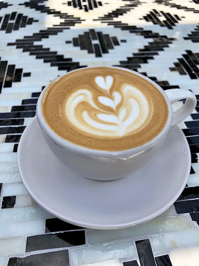 Latte art so pretty you almost don't want to drink it. Almost. That leaf design is practically begging you to ruin its perfection.