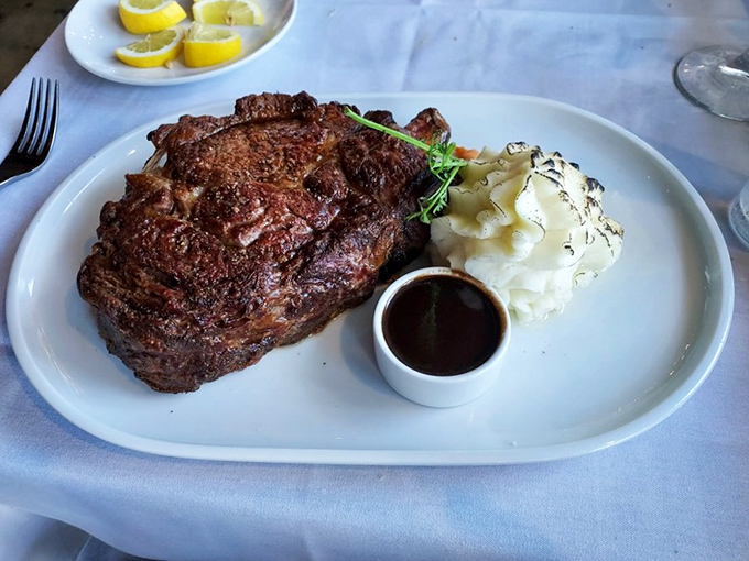 Behold the Delmonico—a steak so perfectly caramelized it should have its own Instagram account. That side of mashed potatoes isn't playing second fiddle; it's a co-star.