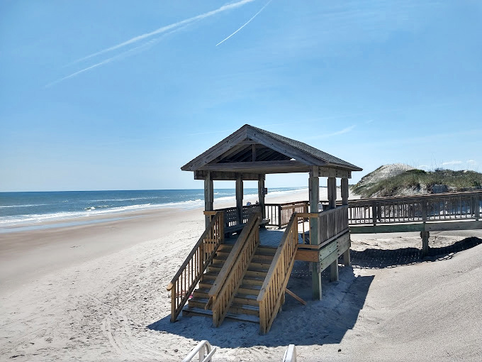Beach access pavilions – where architecture meets necessity. Like a perfect appetizer, they're just enough structure before the main course of nature.
