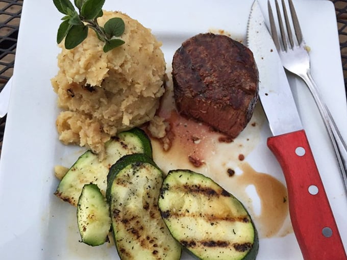 Prime rib that doesn't just sit on the plate—it commands attention, flanked by mashed potatoes standing at the ready. 