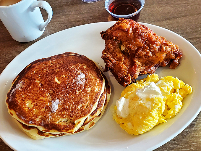 This isn't just breakfast—it's edible architecture. That golden pancake, crispy chicken, and those eggs are the holy trinity of morning salvation.