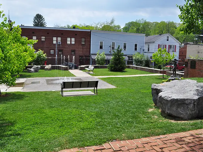 A pocket park where conversations bloom as naturally as the greenery. In small towns, these gathering spaces aren't amenities—they're essential community living rooms.