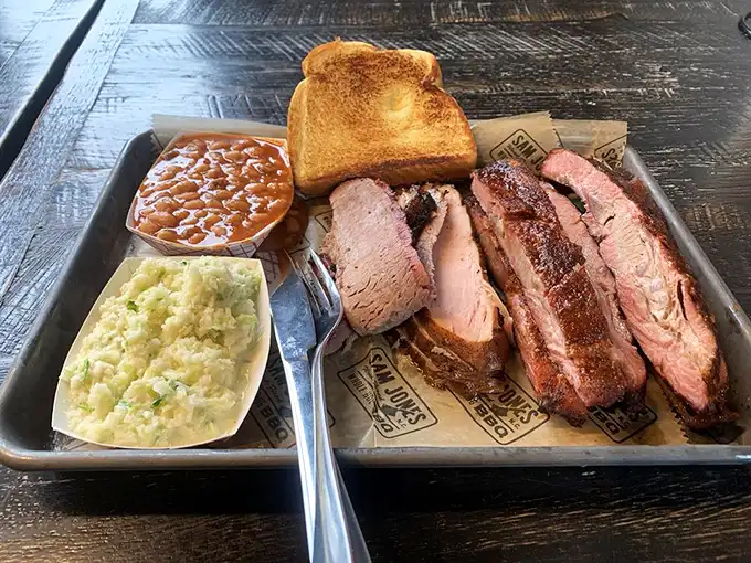 Brisket sliced so perfectly it could make a Texas pitmaster weep with joy, served alongside the kind of sides that demand equal attention.