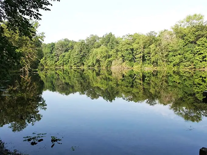 Glassy waters reflect moody skies—nature's version of a perfect mirror selfie without the awkward arm angle.