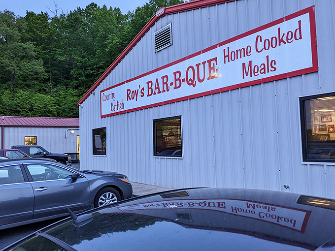 Roy's white building with red trim—like a Christmas present filled with smoky treasures. The reflection in the puddle perfectly captures BBQ daydreams!