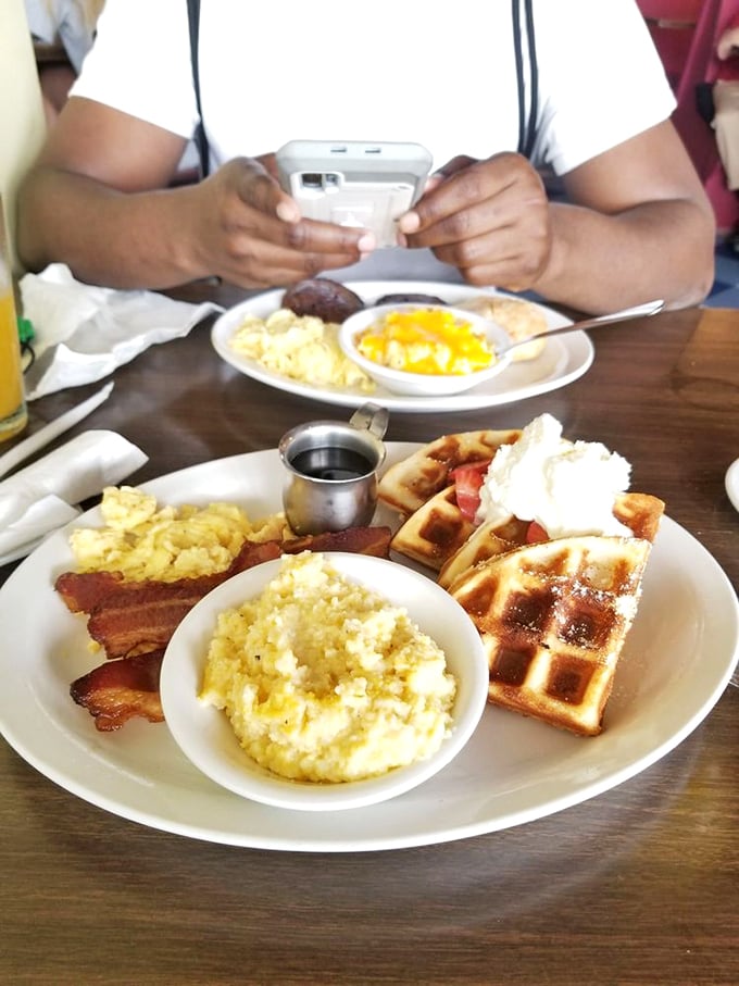 A breakfast plate straight from the dream sequence of a hungry poet—fluffy golden eggs, buttery grits, and bacon with that perfect crisp-to-chew ratio.