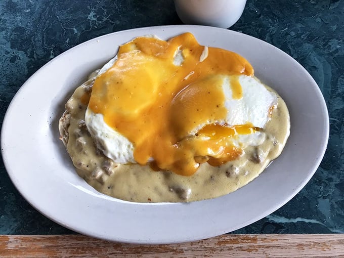 Behold the pinnacle of breakfast engineering: eggs nestled atop a foundation of creamy gravy and cheese. Breakfast architecture at its finest.