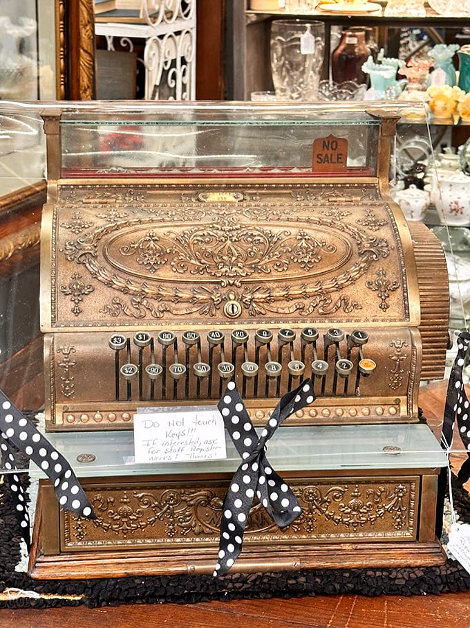 This ornate antique cash register wasn't just functional—it was theater. The "Do Not Touch Keys" sign is the modern equivalent of "look with your eyes, not with your hands."