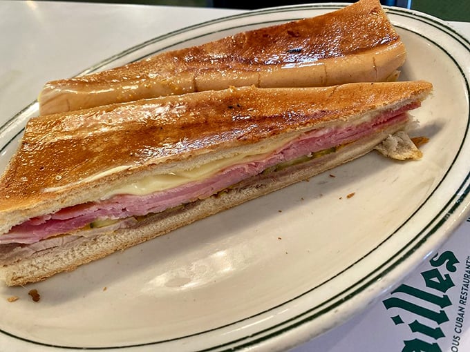 Layer upon glorious layer of ham, roast pork, Swiss cheese, and pickles—architecture so perfect it deserves its own spot on the Miami skyline.