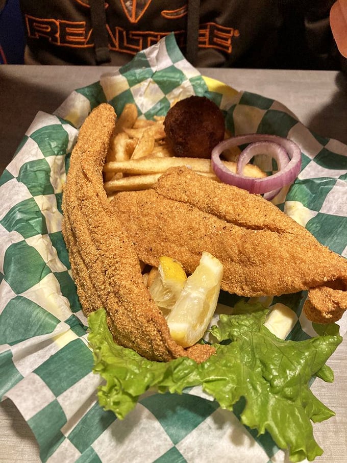 Golden-fried catfish that would make any Southern grandmother nod in approval. The cornmeal coating shatters perfectly with each bite, revealing flaky white fish beneath.