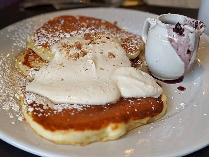 These pancakes don't just sit there looking pretty—they're dressed for success with vanilla chantilly, fresh fruit, and enough maple syrup to make a Canadian blush. 