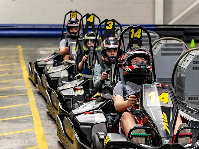 The starting grid – where friendships temporarily pause and the inner Andretti emerges. These helmeted competitors are seconds away from glory or excuses. 