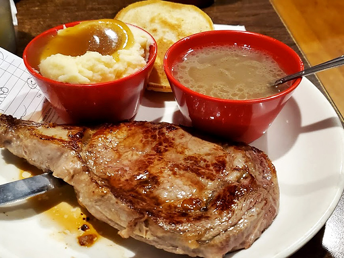 This perfectly seared ribeye with mashed potatoes and gravy isn't just dinner—it's therapy on a plate. The bread's just there for moral support.