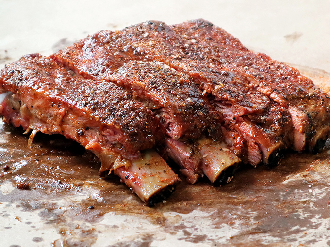 These ribs aren't just falling off the bone – they're practically volunteering to jump onto your plate with a smoky enthusiasm that's contagious.