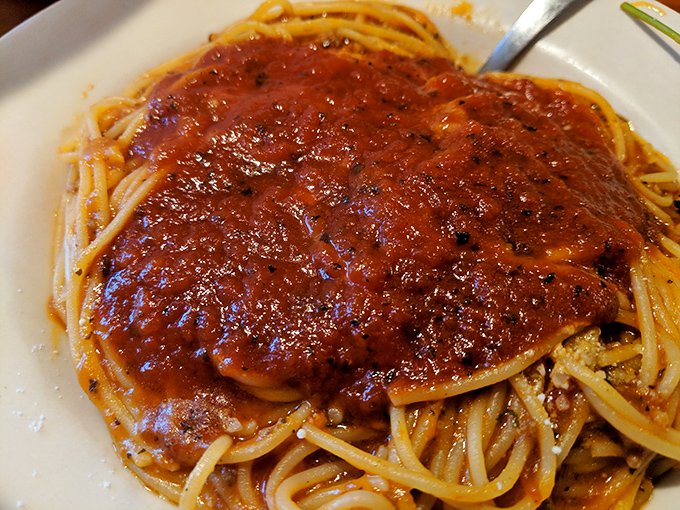 This isn't just meat sauce—it's a rich, savory blanket lovingly tucked around each strand of pasta. Napkins required, restraint optional.