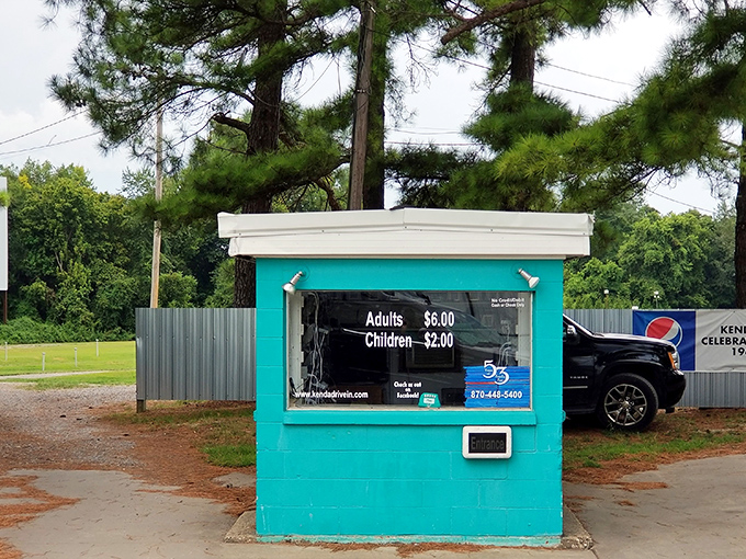 The little turquoise ticket booth—where memories begin with a simple transaction and the promise of cinematic escape.