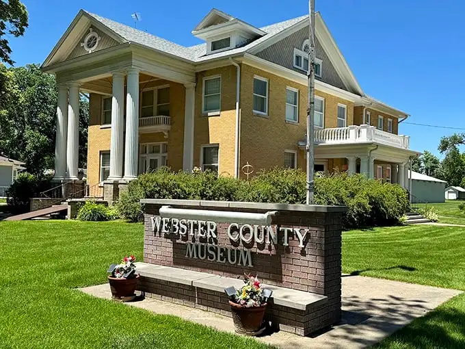 The Webster County Museum isn't just preserving history—it's showing off in this grand yellow brick mansion that would make Gatsby jealous.