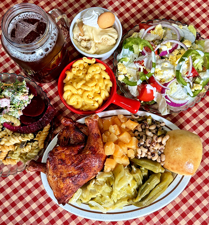 The ultimate Southern feast spread across a checkered tablecloth – proof that sometimes happiness is measured in side dishes and sweet tea.